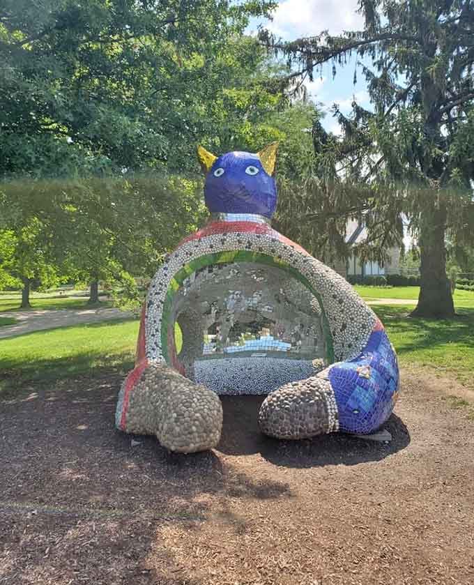 A mosaic creature that's part cat, part dragon, and entirely delightful for kids who love climbing on art.