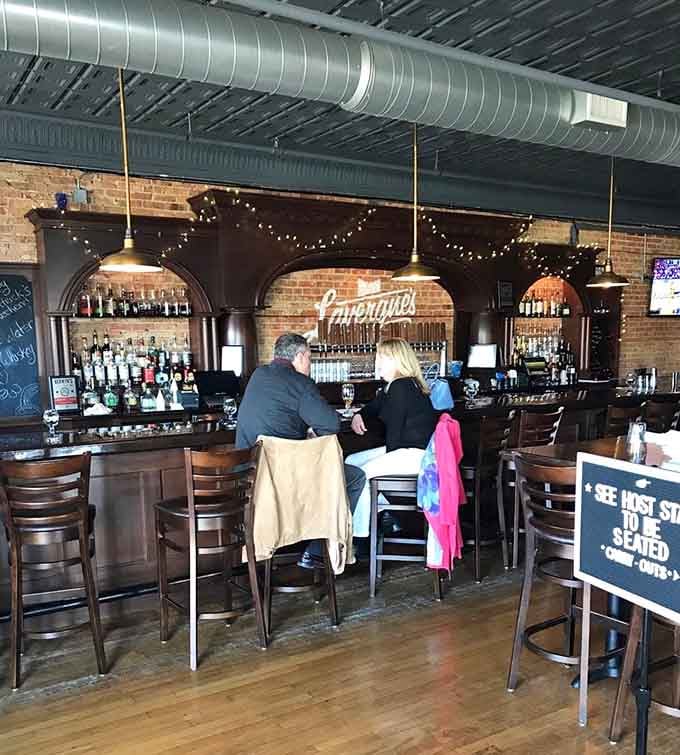The bar area beckons with that perfect neighborhood vibe where strangers become friends over shared appetizers and cold beers.