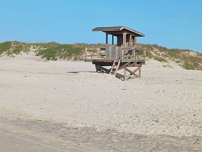That lifeguard tower stands watch like a wooden sentinel protecting your right to relax safely.