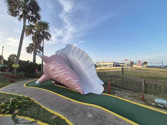That oversized seashell obstacle whispers "beach vibes" while you're desperately trying to avoid a seven-stroke hole.