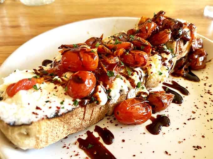 Burrata bruschetta topped with roasted tomatoes proves Italian cuisine thrives even in the Chihuahuan Desert's embrace.