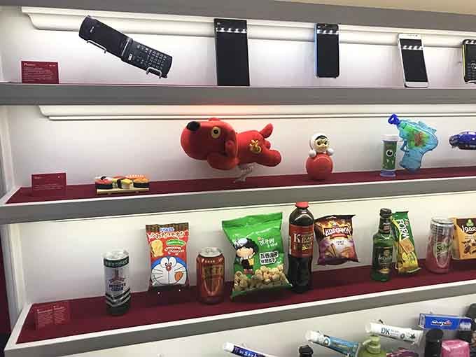 From flip phones to stuffed animals, this shelf captures the beautiful chaos of global consumer culture in miniature.
