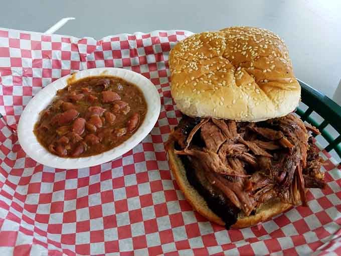 That brisket sandwich is piled so high it defies physics, paired perfectly with those creamy red beans alongside.