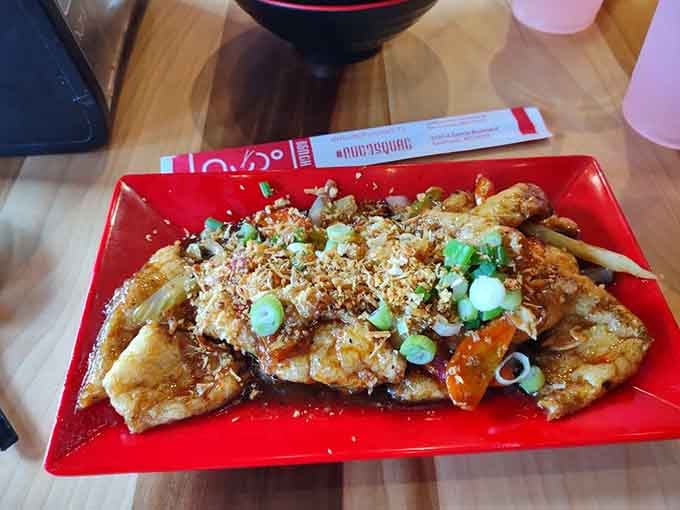 Tamarind tofu gets dressed up with crushed peanuts and scallions, proving vegetables can absolutely steal the show.