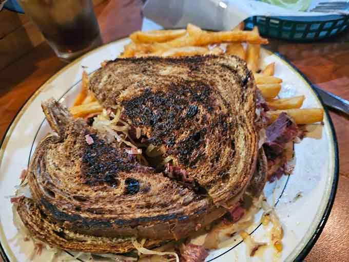 That Reuben on marbled rye looks like it walked straight out of a deli dream and onto your very lucky plate.