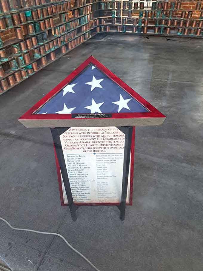 A folded flag honors veterans who received treatment here, adding another layer to this complex history.