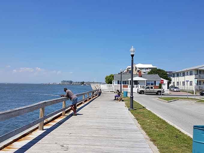 Sunshine warms the wooden boardwalk as you watch a peaceful fisherman cast his line into the sparkling, deep blue bay.