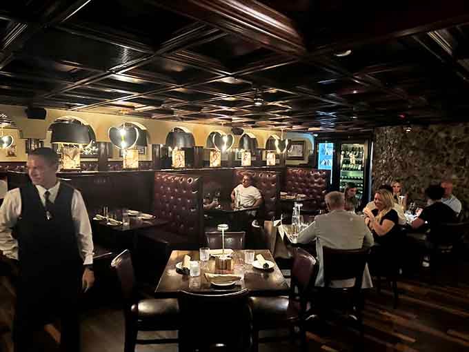 Tufted leather booths and mood lighting create the perfect setting for conversations that linger long after dinner ends.