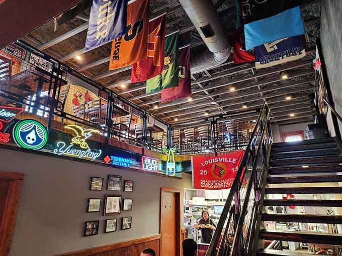 Sports flags hanging from the rafters like trophies, because every tavern needs its team spirit on display.