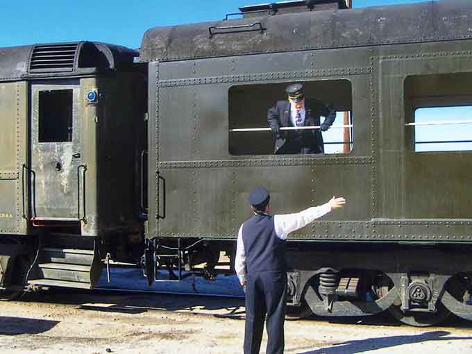 Dedicated volunteers in period uniforms keeping history alive, one train ride and enthusiastic wave at a time.