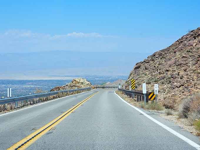Through the windshield, mountains beckon with the promise of cooler air and better cell reception.