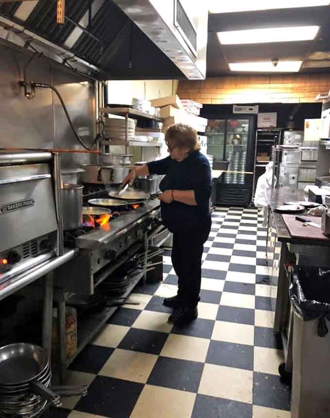 Behind every great pasta flight is a dedicated cook working the flames on a classic checkered kitchen floor.