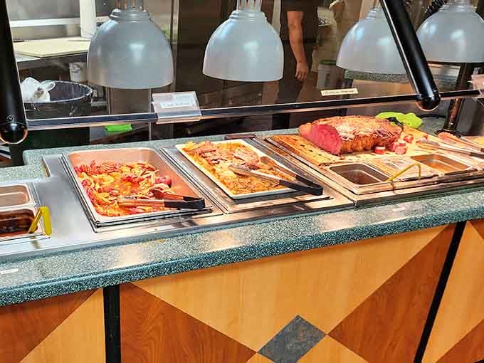 Hot stations keeping prime rib and crab legs at perfect temperature, because cold seafood is nobody's friend.