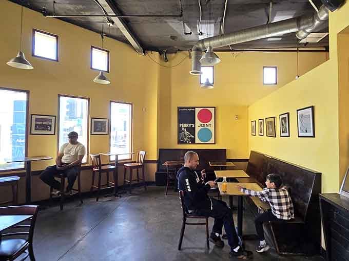 Sunny yellow walls and booth seating create the perfect spot to tackle your towering sandwich conquest.