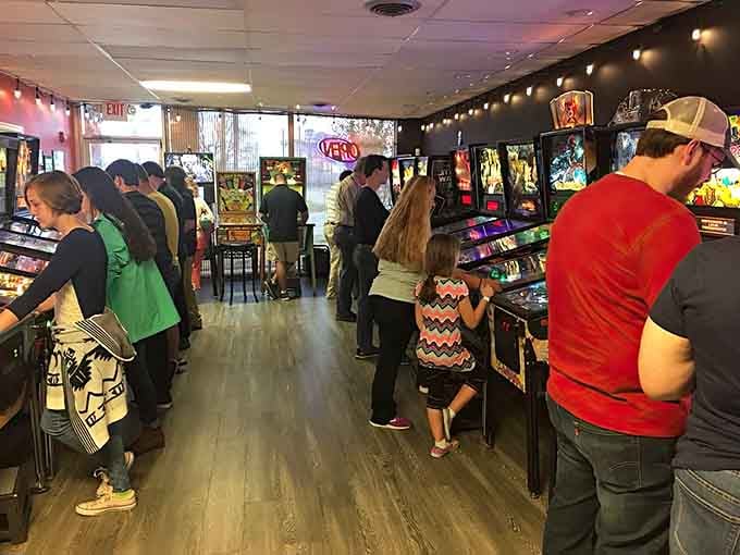 Three generations united by flippers and high scores, proving some entertainment never needs an internet connection.