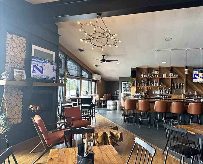 Large windows frame the view while a striking fireplace adds cozy ambiance to your dining experience.