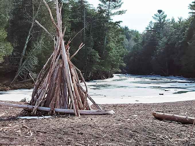 Someone built a driftwood teepee on the beach, proving that creative expression happens even in the wilderness.