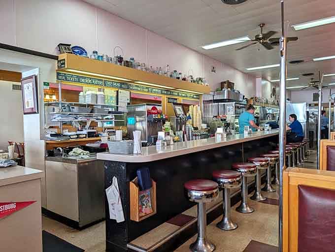 The counter where regulars claim their spots like reserved parking, complete with unspoken seating rules and traditions.