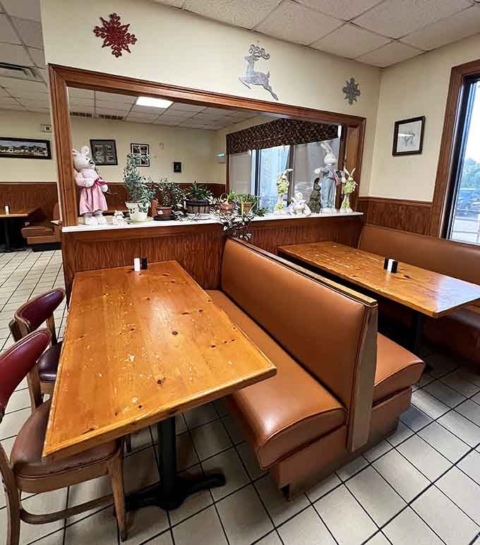 Booth seating with wood paneling and seasonal decorations creates that cozy diner vibe we all secretly crave.