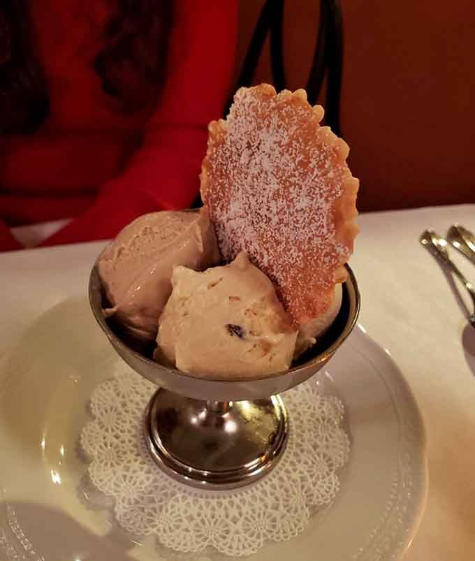 Gelato served with a delicate cookie wafer, because even dessert deserves architectural interest and textural contrast in every bite.