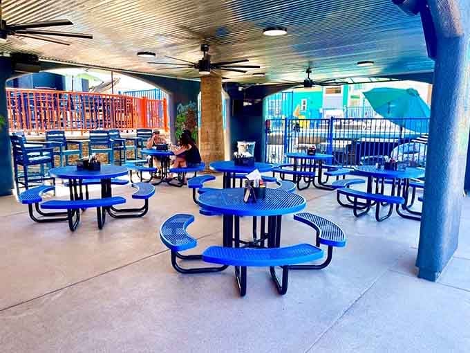 Bright blue tables under covered seating offer the perfect spot to refuel between aquatic adventures and afternoon relaxation.