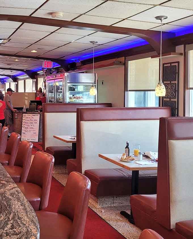 Booth seating bathed in that signature neon glow makes every meal feel like a special occasion.