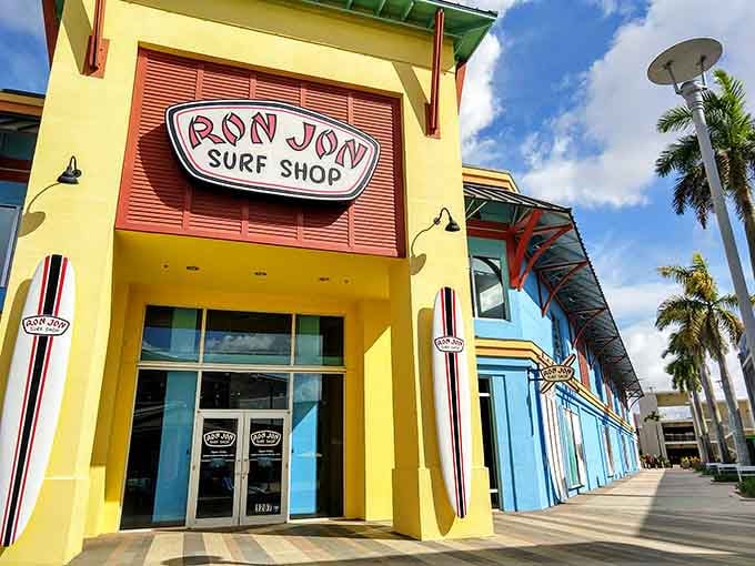 Ron Jon's bright yellow storefront channels pure beach vibes, making you forget you're actually inside a massive shopping complex.