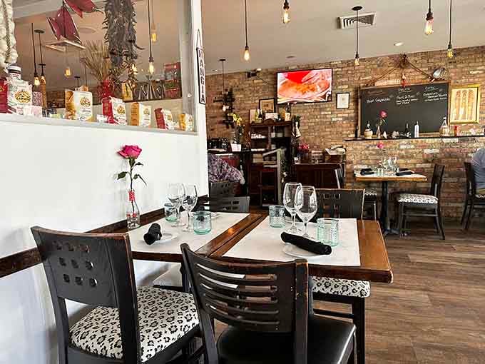 Cozy dining room where exposed brick meets comfortable seating and the promise of exceptional homemade pasta awaits.