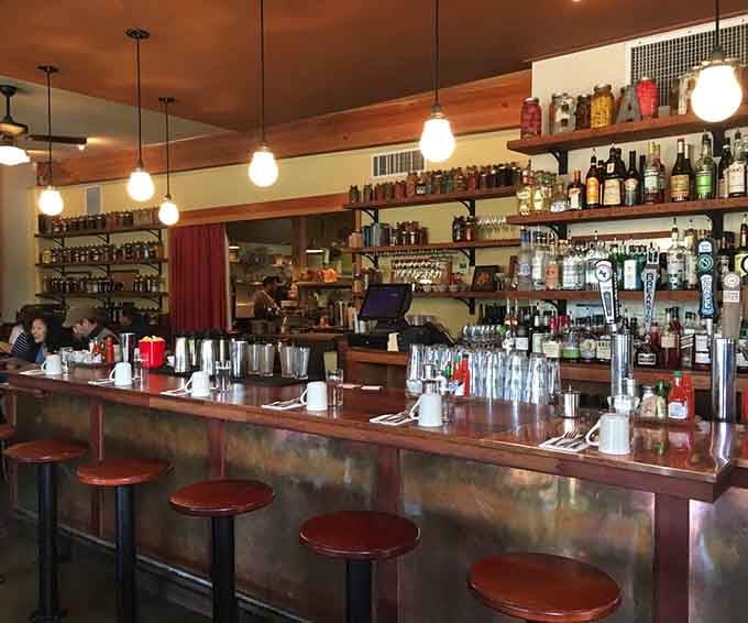 The well-stocked bar gleams with promise, ready to turn ordinary orange juice into celebratory mimosas all day long.