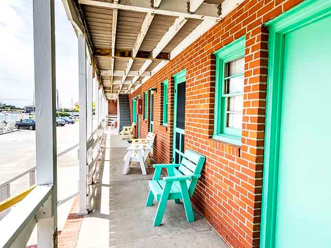 Turquoise doors and white railings create an Instagram-worthy corridor that didn't need social media to know it looked good.