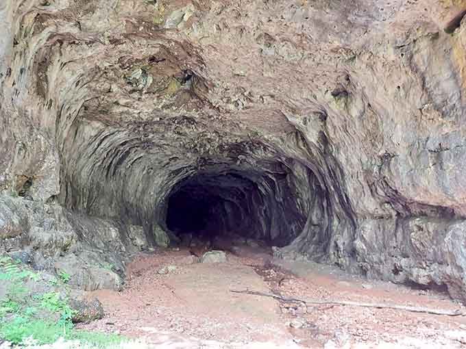 The cave's entrance beckons like nature's own cathedral, massive and humbling in equal measure.