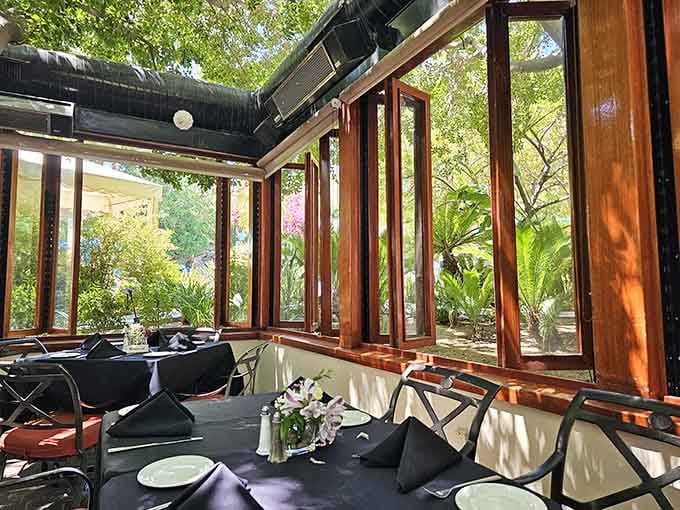 Natural light floods the enclosed patio, creating that perfect Instagram-worthy glow without even trying hard.