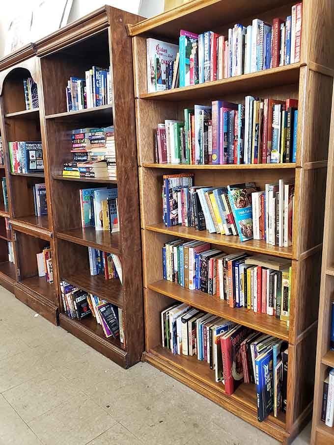 Wooden bookshelves filled with reading material, where your next favorite author might be waiting between well-loved pages.