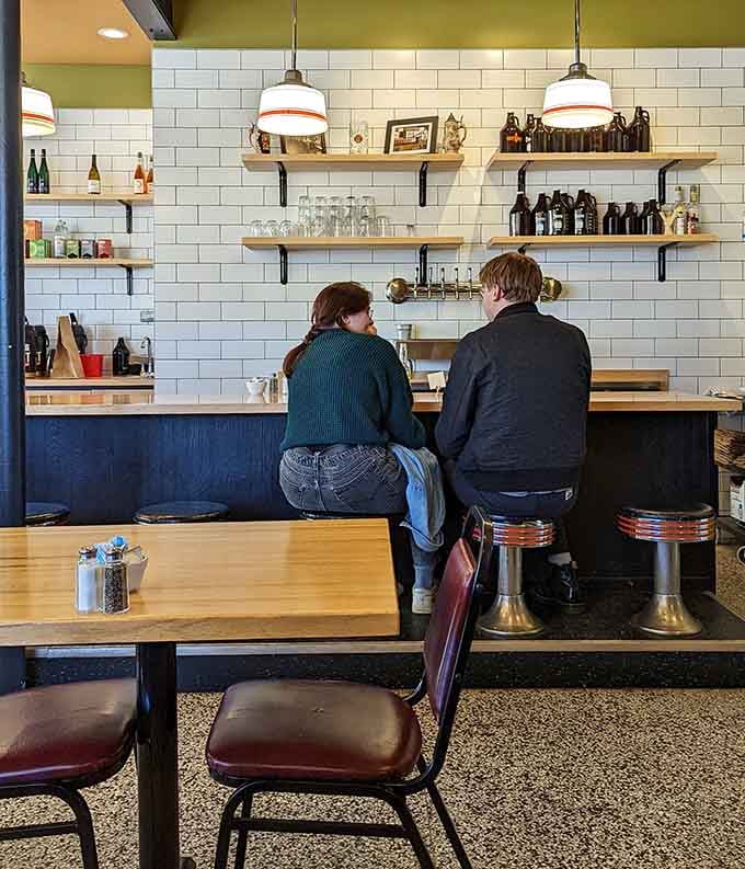 Comfortable seating and framed photographs create an inviting atmosphere that makes you want to linger after eating.