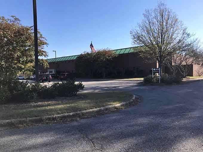 The American flag waves proudly over this postal facility, reminding us that even mail delivery deserves a touch of patriotic spirit.