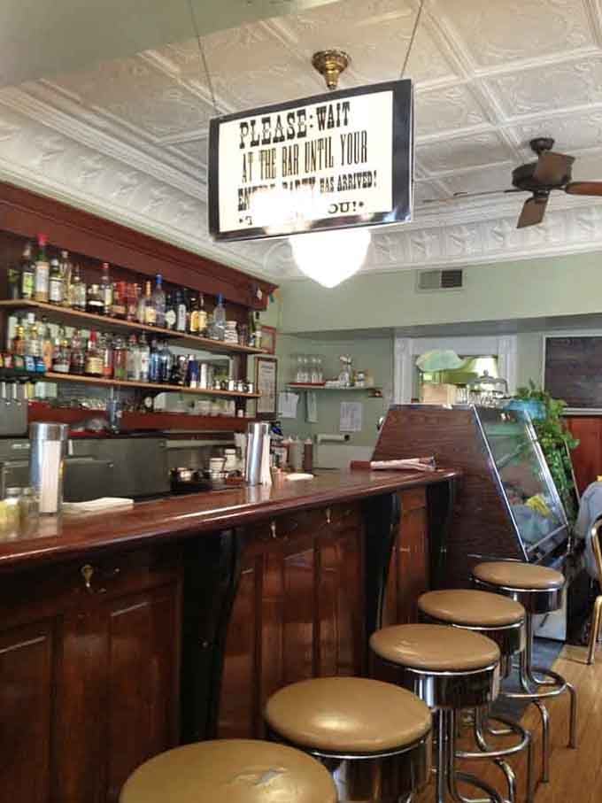 That vintage bar area whispers stories of a thousand sandwiches served with genuine Kentucky hospitality.