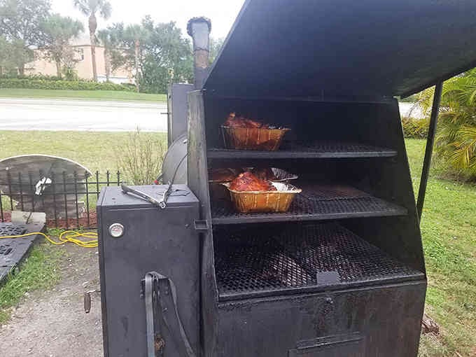 Inside the smoker where meat transforms into something transcendent, one patient hour at a time with hickory smoke.