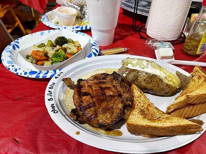 Pork chops paired with a loaded baked potato and vegetables, proving diners can do fancy when they want.