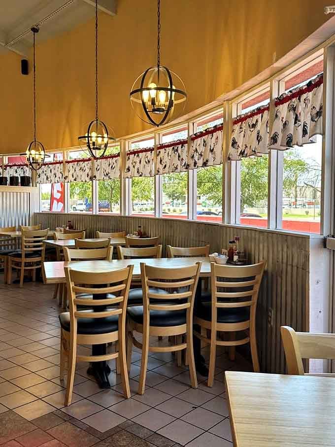 Bright windows, comfortable booths, and pendant lighting create a space where lingering over breakfast feels absolutely mandatory.