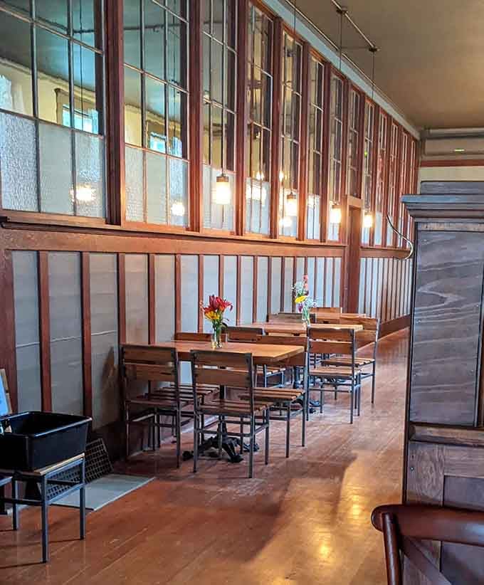 Pendant lights and wooden booths create an atmosphere where time slows down and pizza tastes even better.