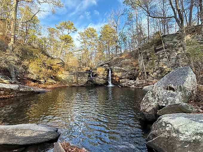 Nature's own infinity pool reflects autumn skies, framed by layered rocks that time carved with infinite care.