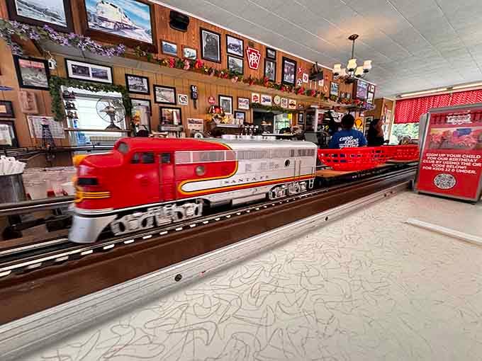 The Santa Fe locomotive glides along its track carrying someone's lunch, because normal food delivery is clearly overrated here.