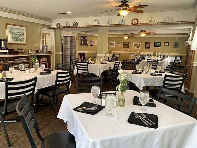 White tablecloths and decorative plates lining the walls create an atmosphere that says "stay awhile, relax."
