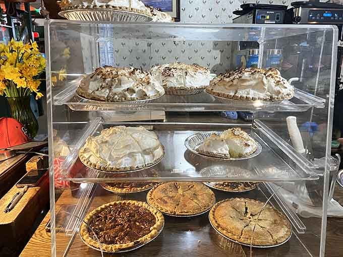 That pie case holds more temptation than you can handle—multiple varieties waiting to ruin your diet plans completely.