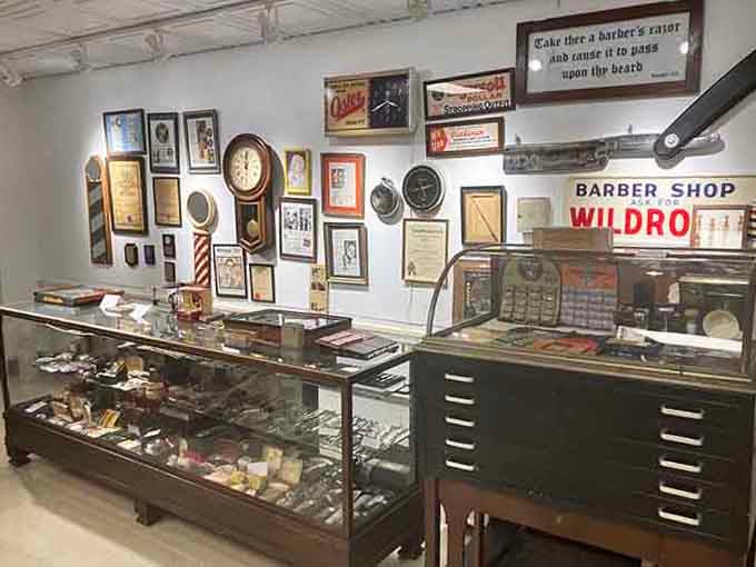 Display cases filled with antique razors, scissors, and tools reveal the precision instruments that made barbering an art form.