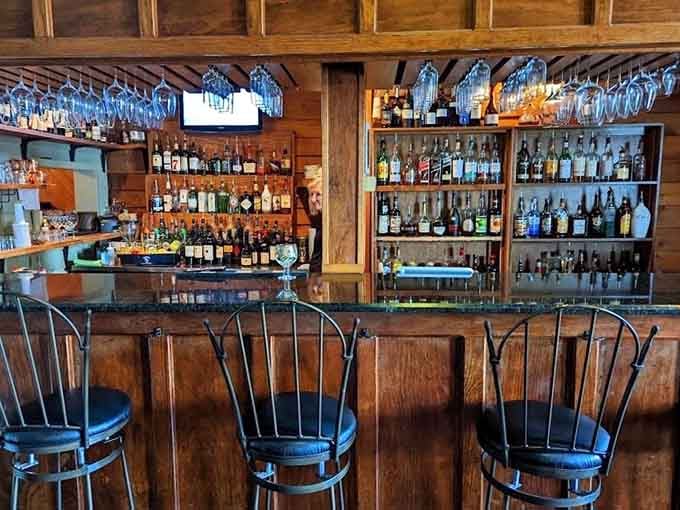 The bar area showcases an impressive spirits collection, ready to complement your meal with the perfect pour every time.