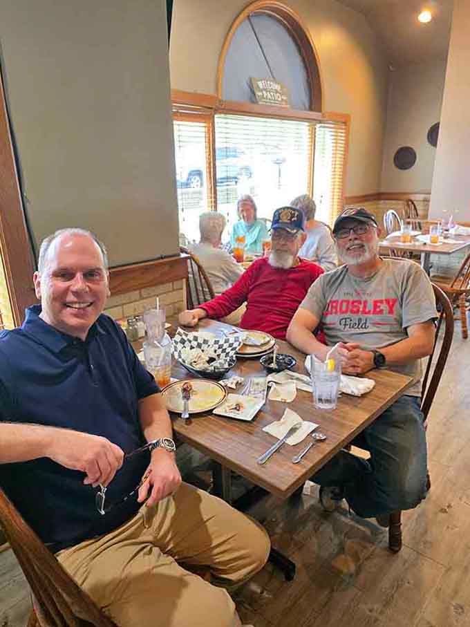Happy diners gathered around the table, sharing stories and smiles, capturing the true spirit of community dining done right.