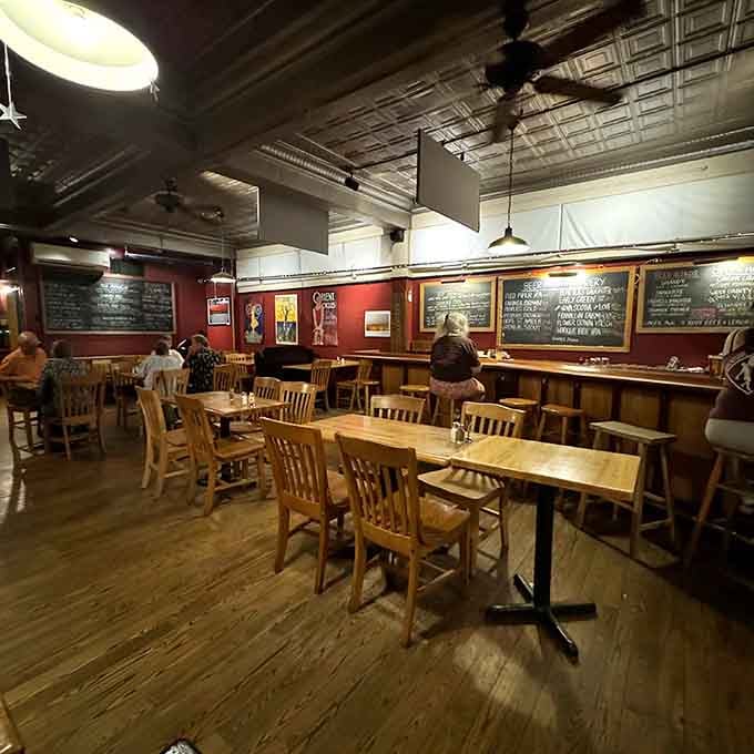 Light wood tables and deep red walls create a space that feels both energizing and wonderfully relaxing.
