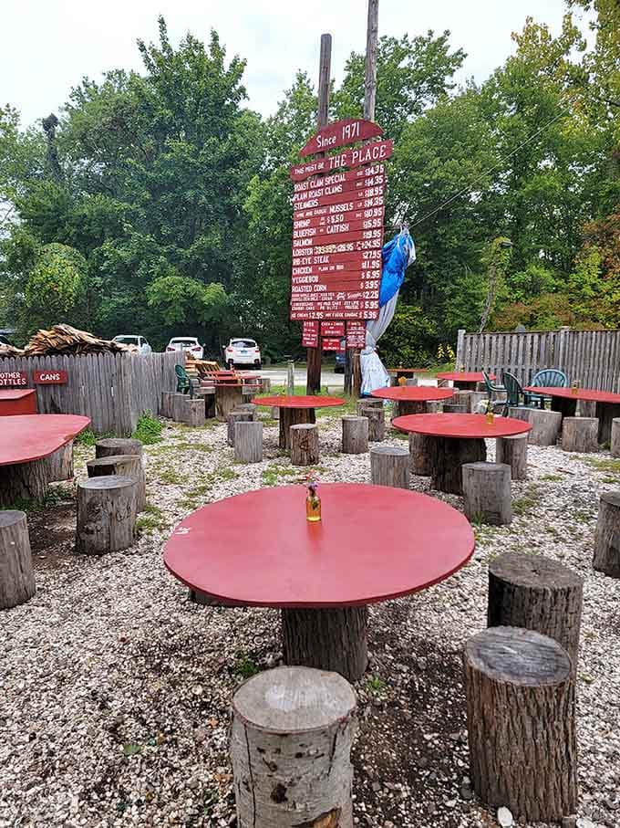 Red tables, tree-stump stools, and gravel underfoot create an atmosphere that's equal parts rustic charm and pure Connecticut magic.