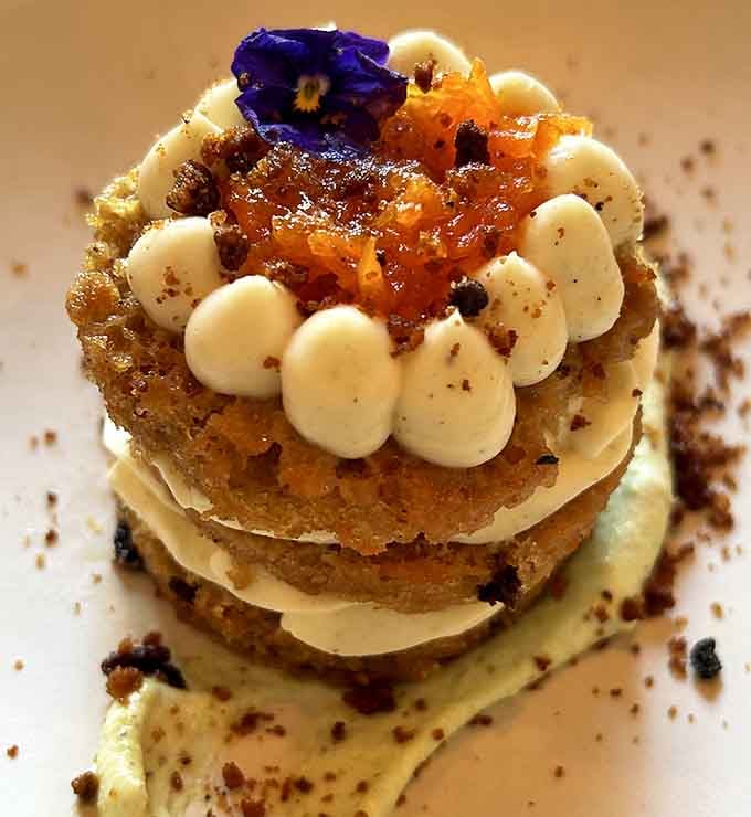 Carrot cake stacked high with cream cheese frosting, making vegetables the hero we didn't know we needed.